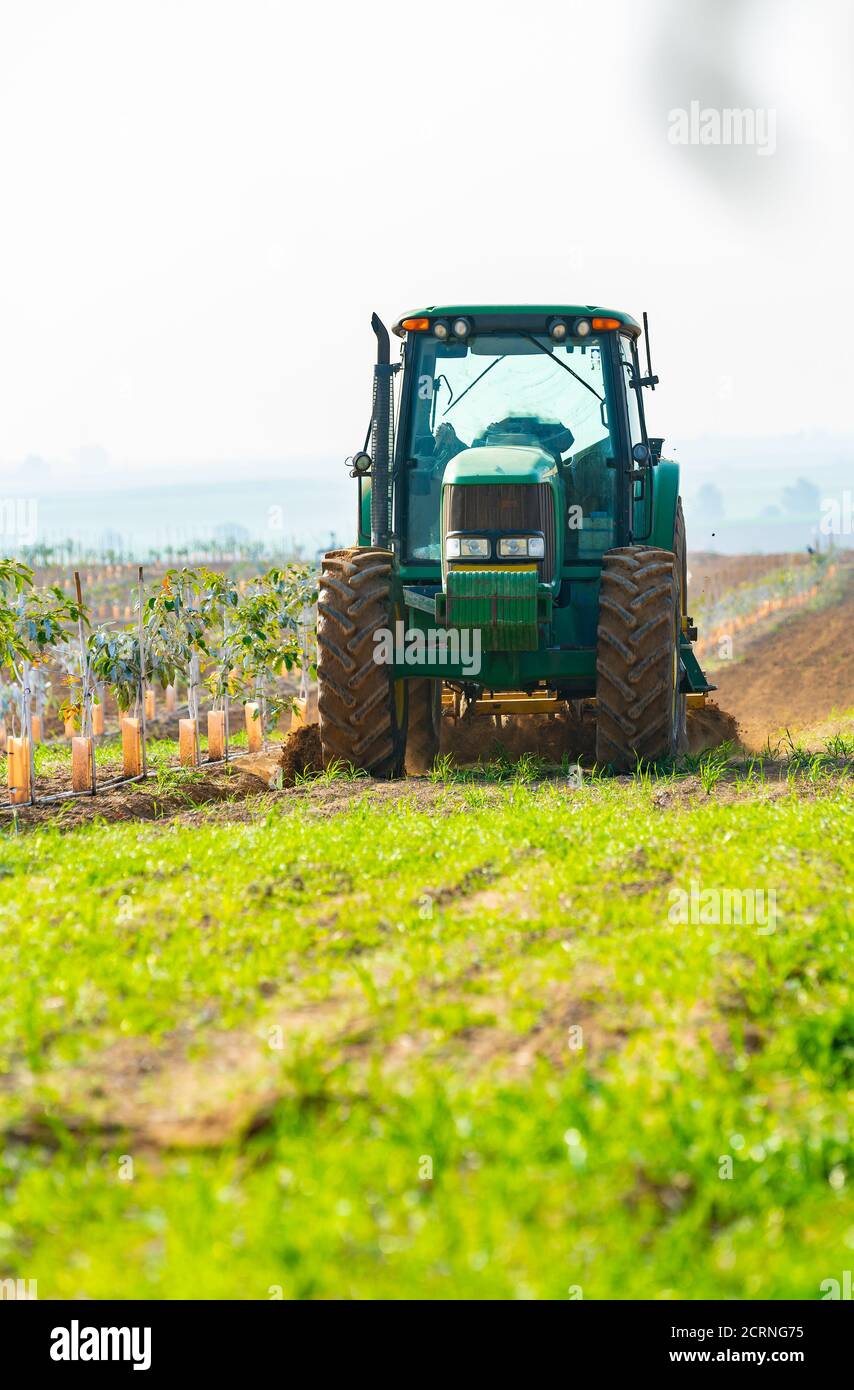 rural landscape, tractor cultivates agricultural land Stock Photo - Alamy