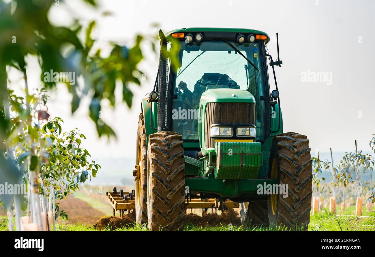 rural landscape, tractor cultivates agricultural land Stock Photo - Alamy
