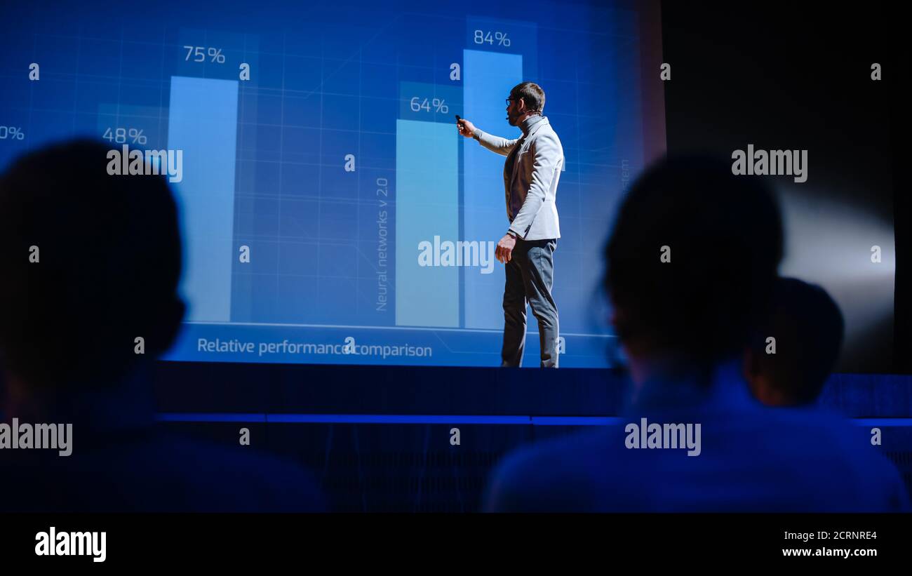 On Stage Visionary Male Speaker Presents New Technology, Uses Remote ...