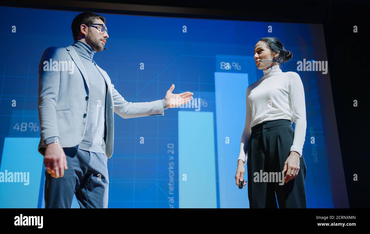 On Stage, Successful Female Executive and Male Manager Present New ...