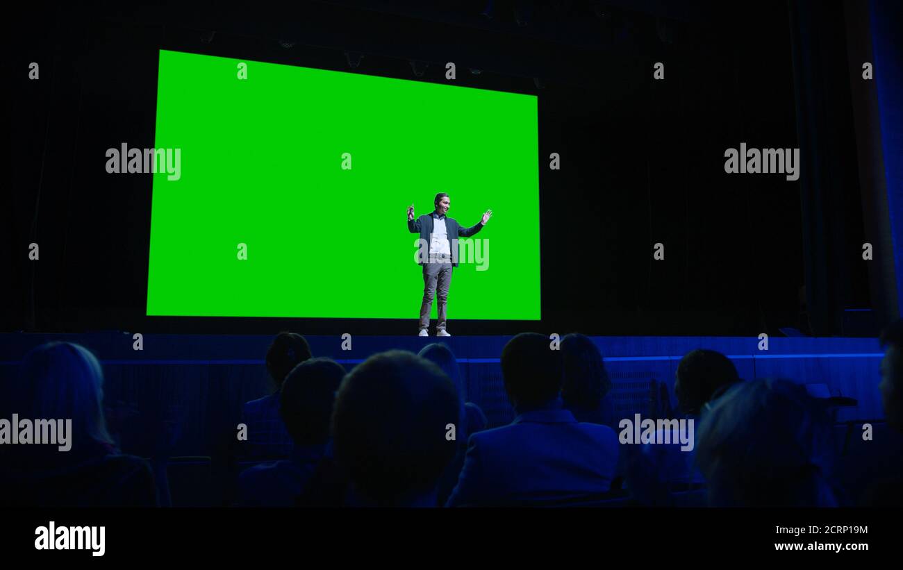 On Stage, Keynote Speaker Presents New Product to the Audience, Behind ...