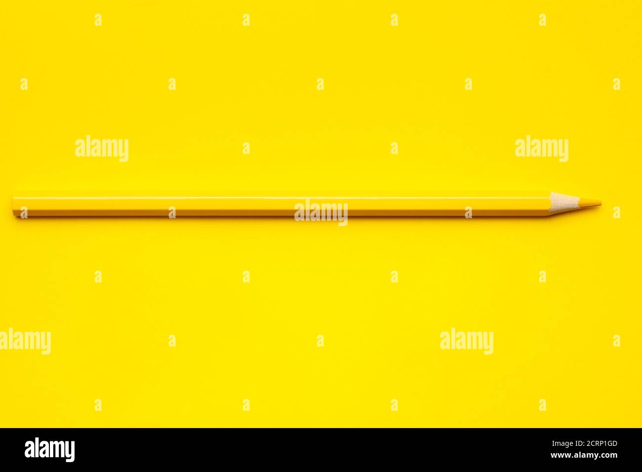 horizontal yellow sharp wooden pencil on a bright yellow background ...