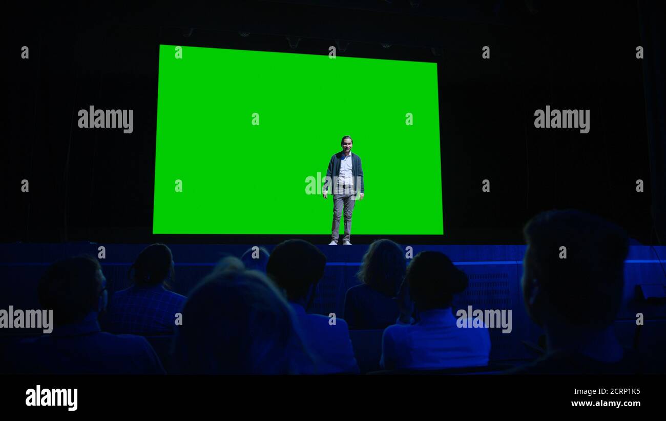 On Stage, Keynote Speaker Presents New Product to the Audience, Behind ...
