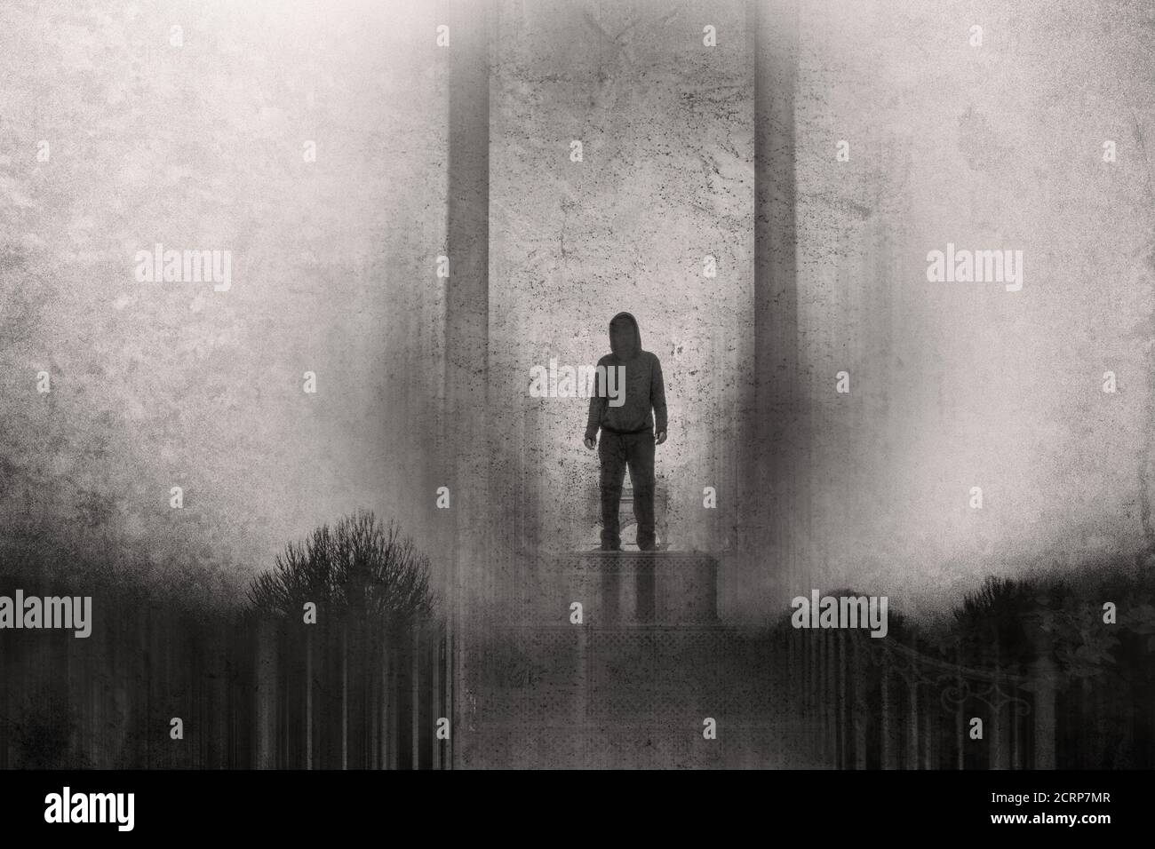 A scary hooded figure standing on top of a staircase. With a blurred ...