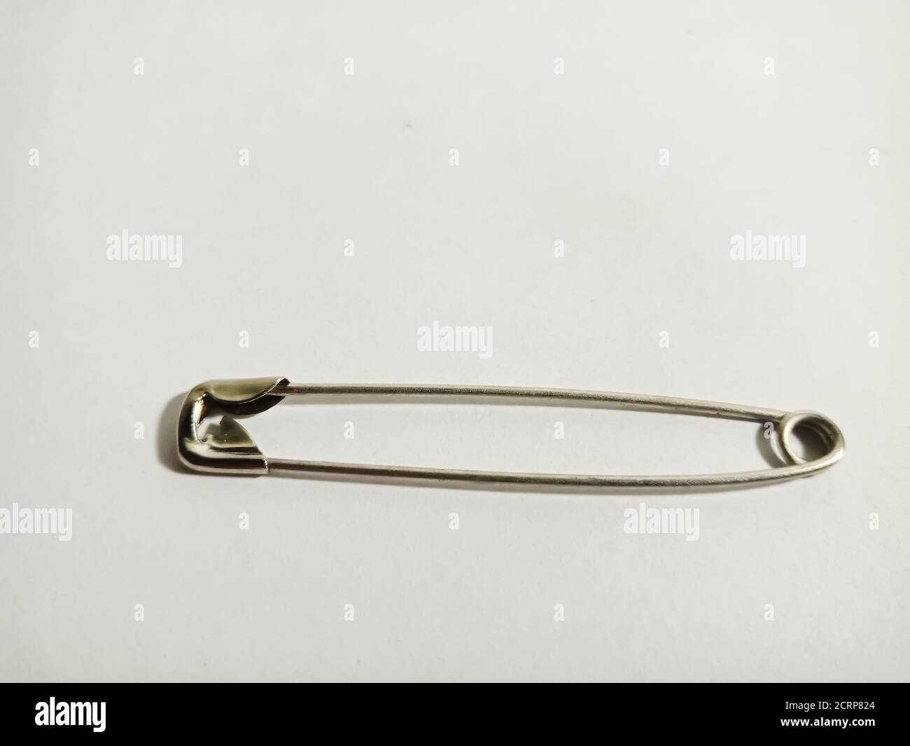 Single Safety pin isolated on white background for marketing and ...