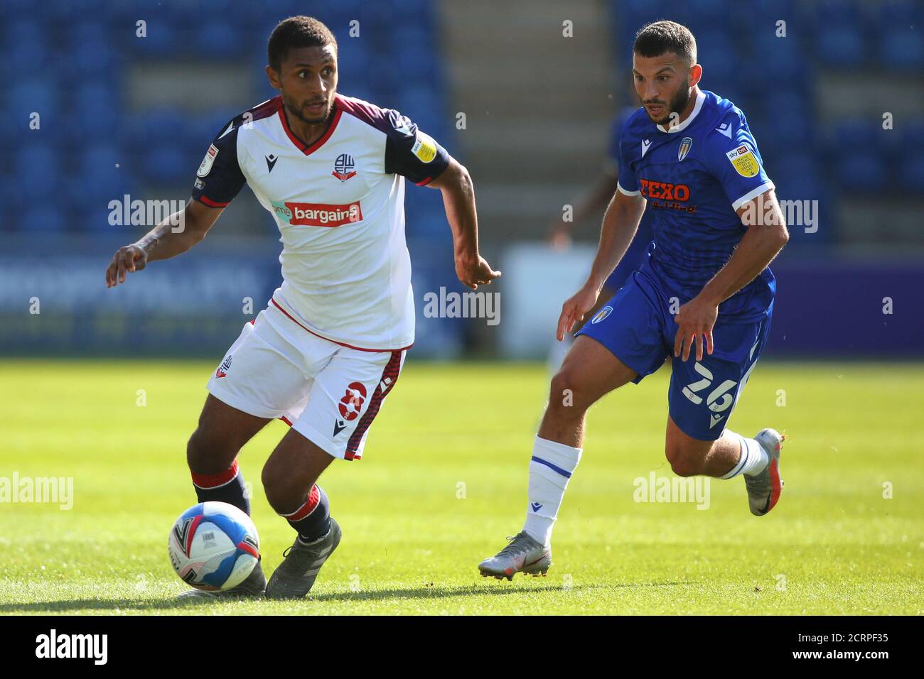 Brandon Comley of Bolton Wanderers and Luke Gambin of Colchester United ...