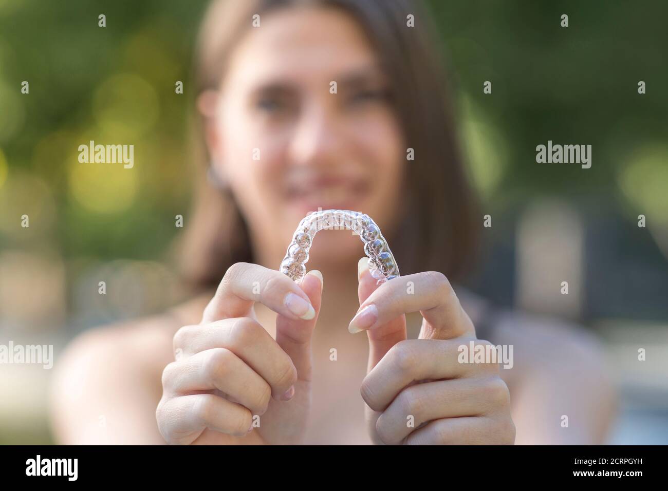 Beautiful smiling Turkish woman is holding an invisalign bracer Stock ...