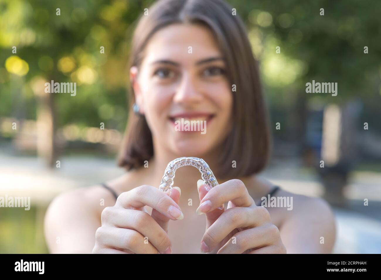 Beautiful smiling Turkish woman is holding an invisalign bracer Stock ...