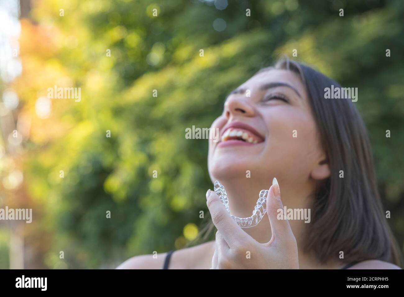 Beautiful smiling Turkish woman is holding an invisalign bracer Stock ...