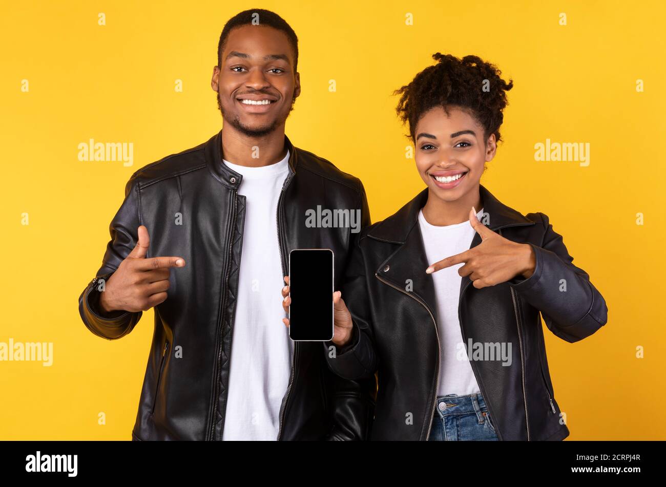 Black Couple Showing Smartphone With Blank Screen Over Yellow ...