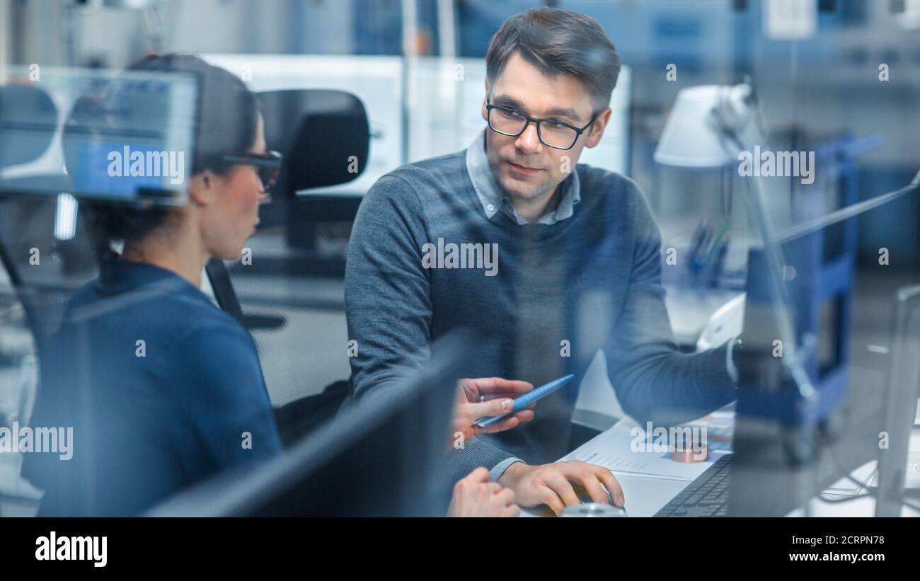 Shot Through Glass in Modern Factory: Female Project Supervisor Talks ...