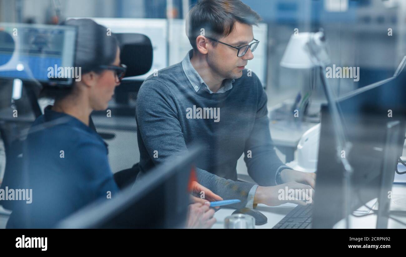 Shot Through Glass in Modern Factory: Female Project Supervisor Talks ...