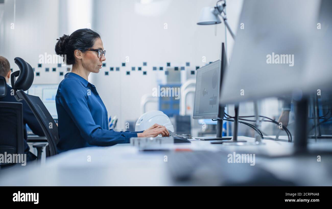 Low Angle Shot of a Female Engineer Working on Personal Computer. She ...