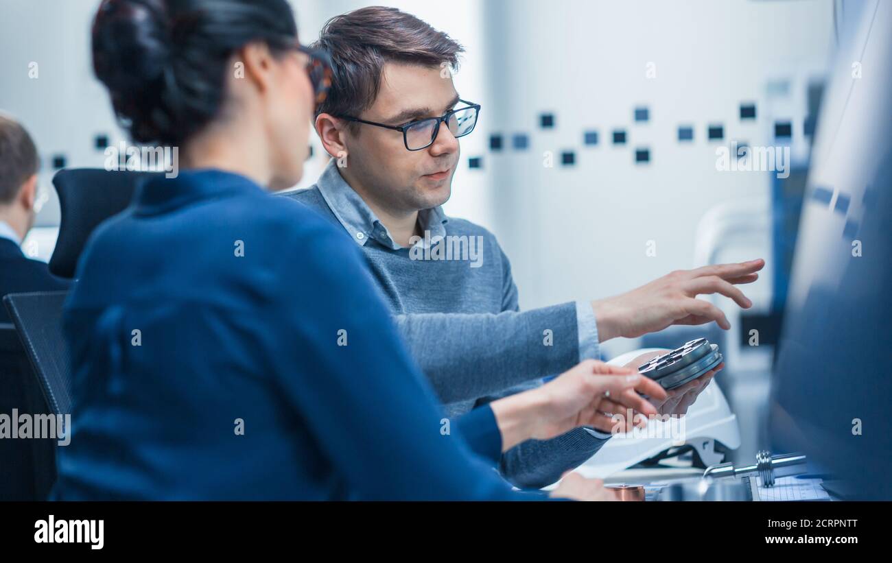 Modern Factory: Male Industrial Engineer Explains to Female Project ...