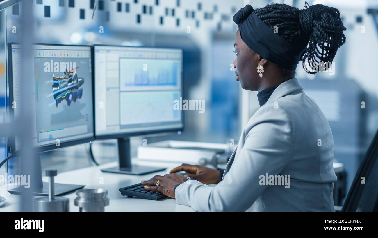 Beautiful Female Engineer Working on Personal Computer in the High-Tech ...