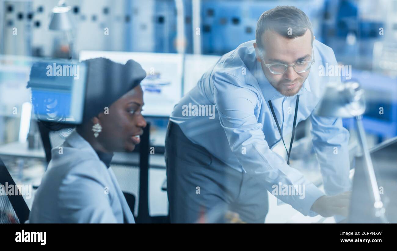 Modern Factory: Male Project Supervisor Talks to a Female Industrial ...