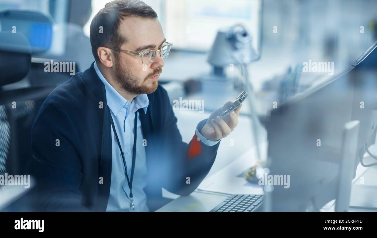 Electronics Factory: Male Electrical Engineer Holds PCB Prototype ...
