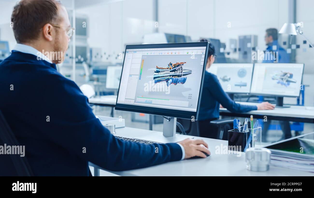Over Shoulder: Heavy Industry Engineer Working on Personal Computer ...