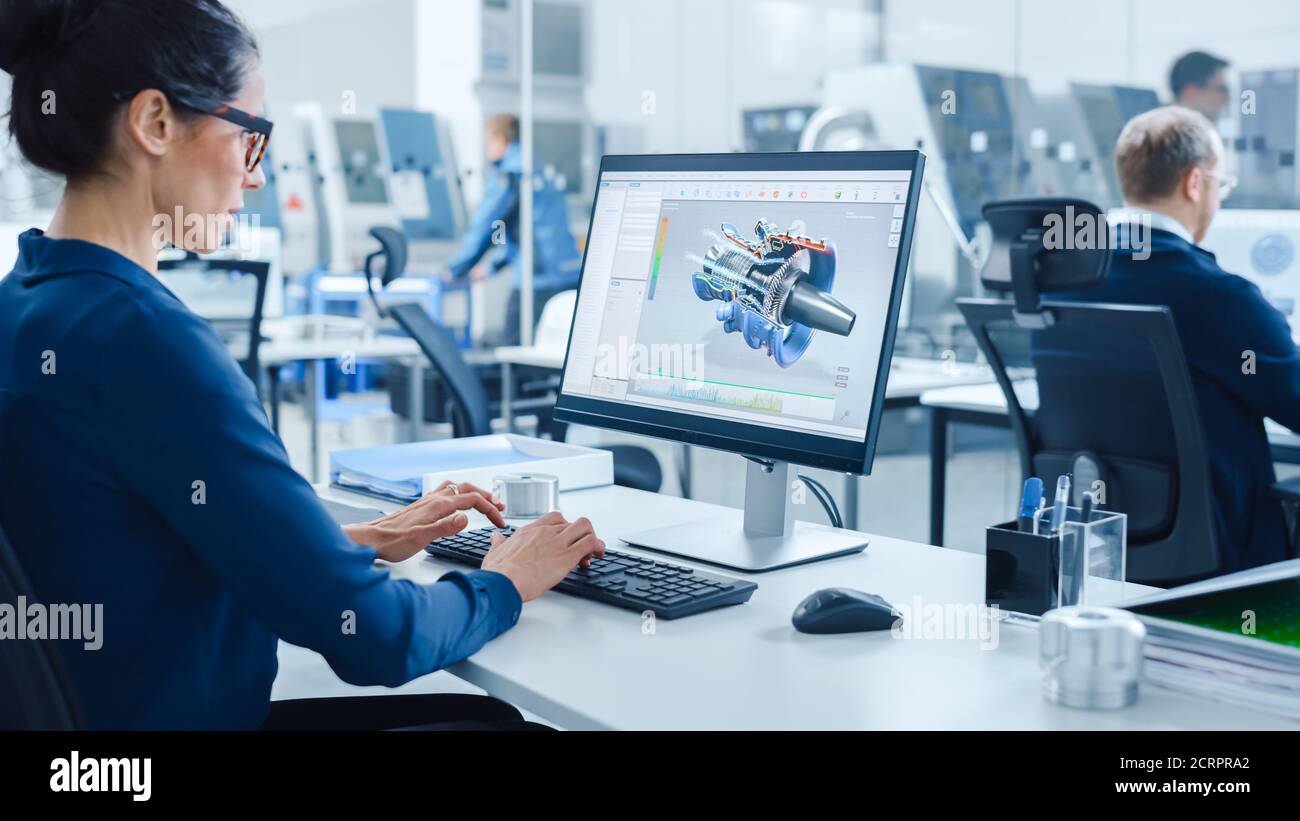Industrial female Engineer Working on a Personal Computer, Screen Shows ...