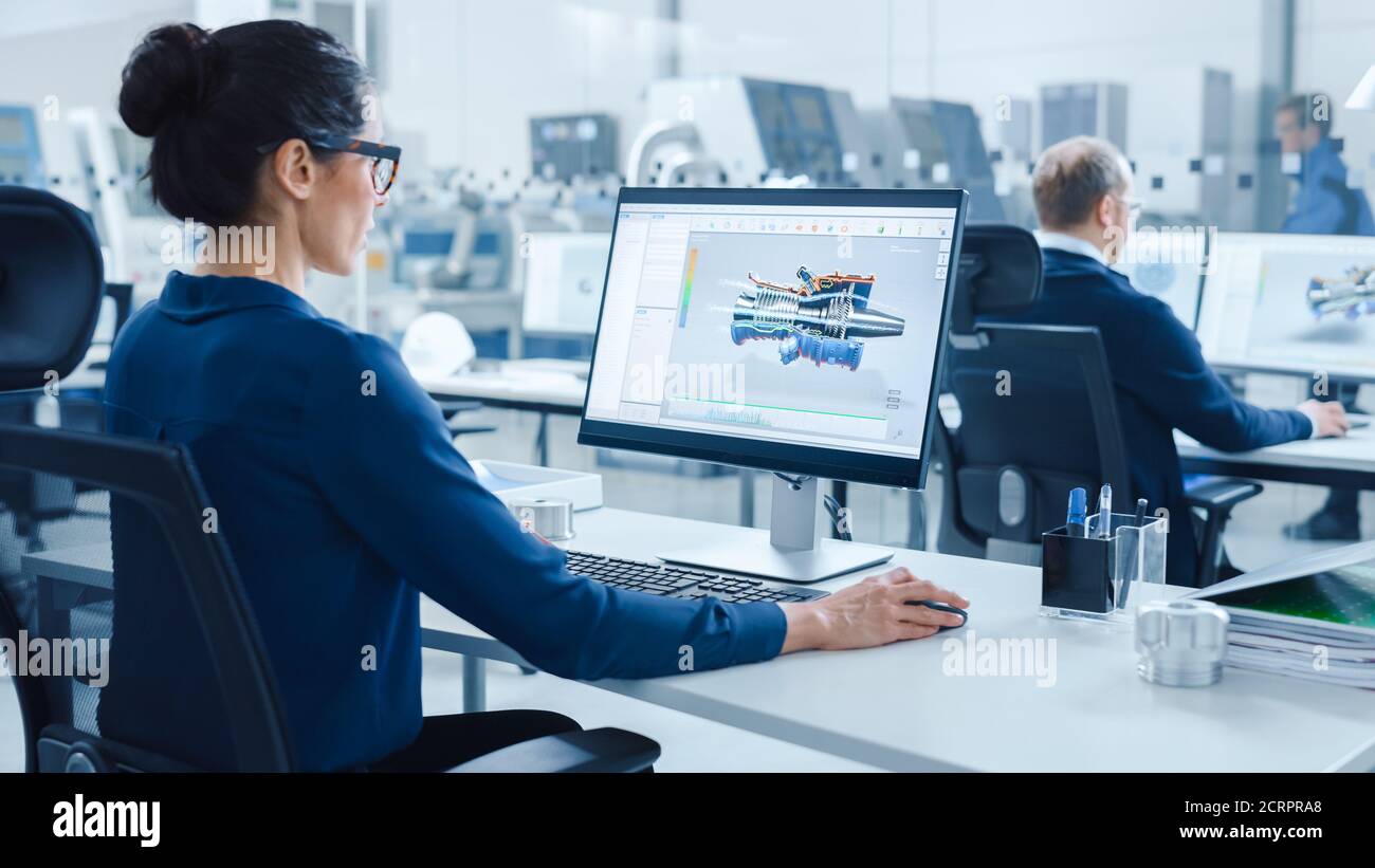 Industrial female Engineer Working on a Personal Computer, Screen Shows ...