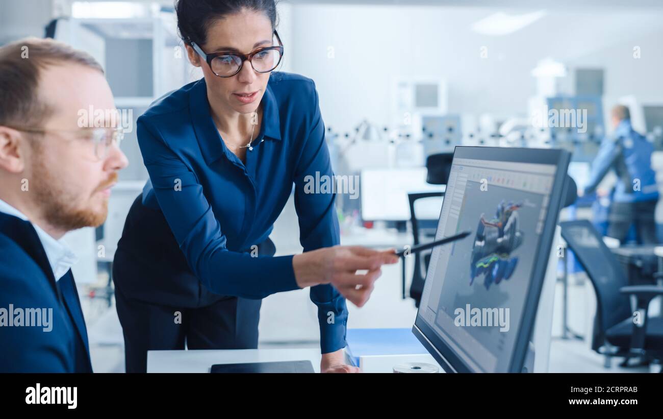 Modern Factory: Female Project Supervisor Talks to a Male Industrial ...