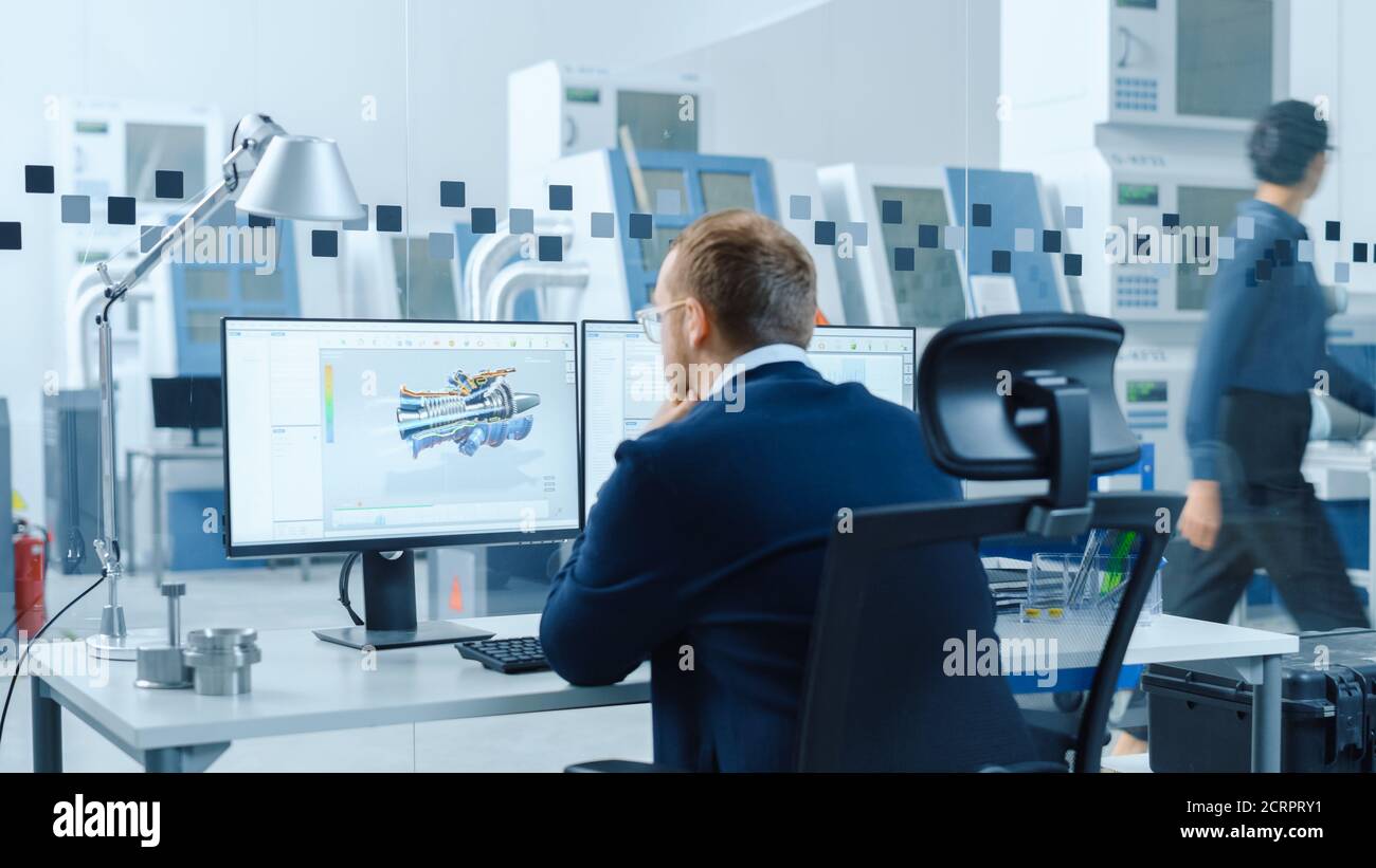 Industrial Engineer Solving Problems, Working on a Personal Computer ...