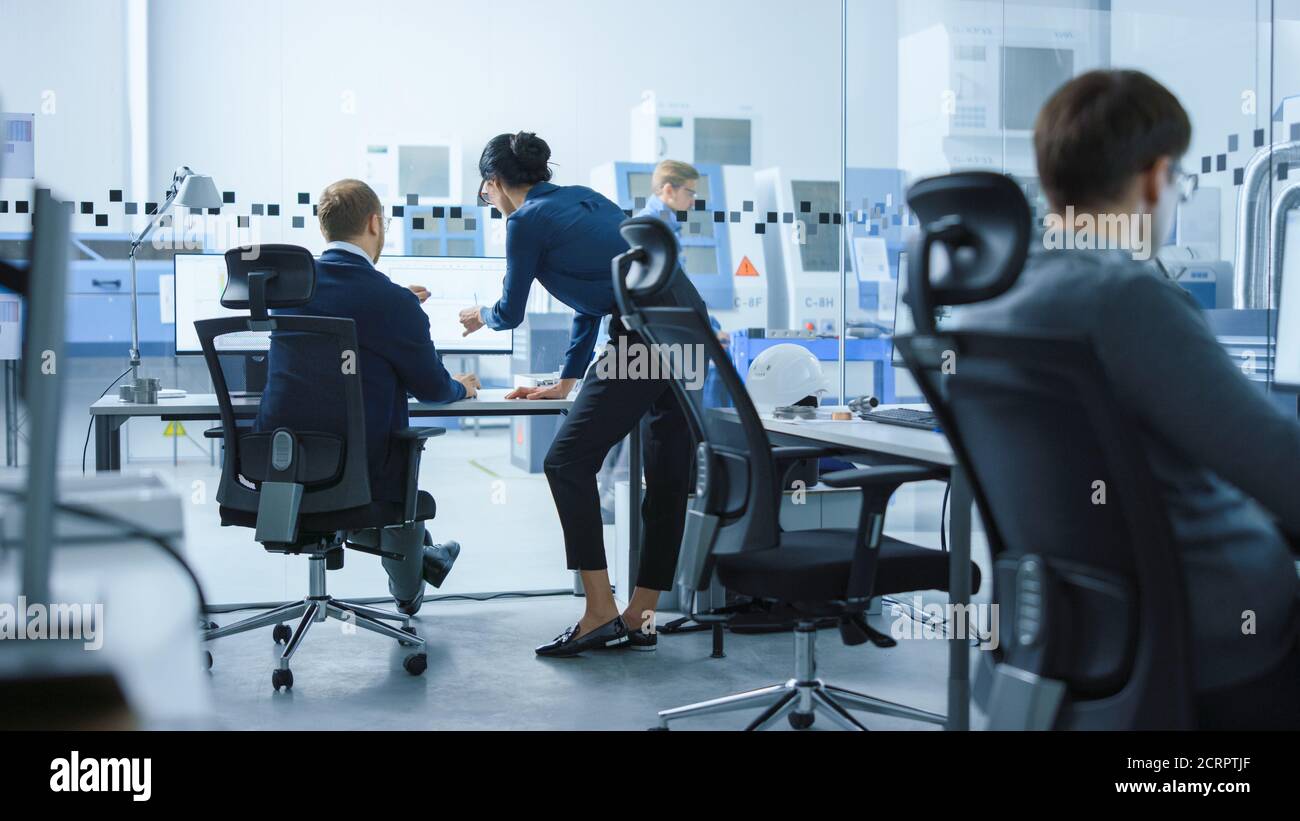 Modern Factory: Female Project Supervisor Talks to a Male Industrial ...