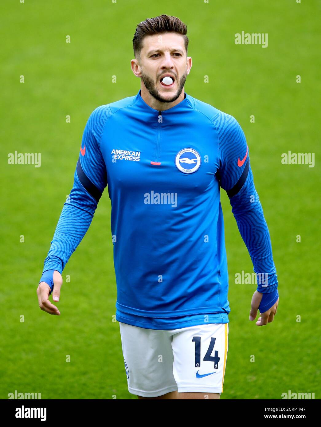 Brighton and Hove Albion's Adam Lallana blows a bubble with his chewing ...