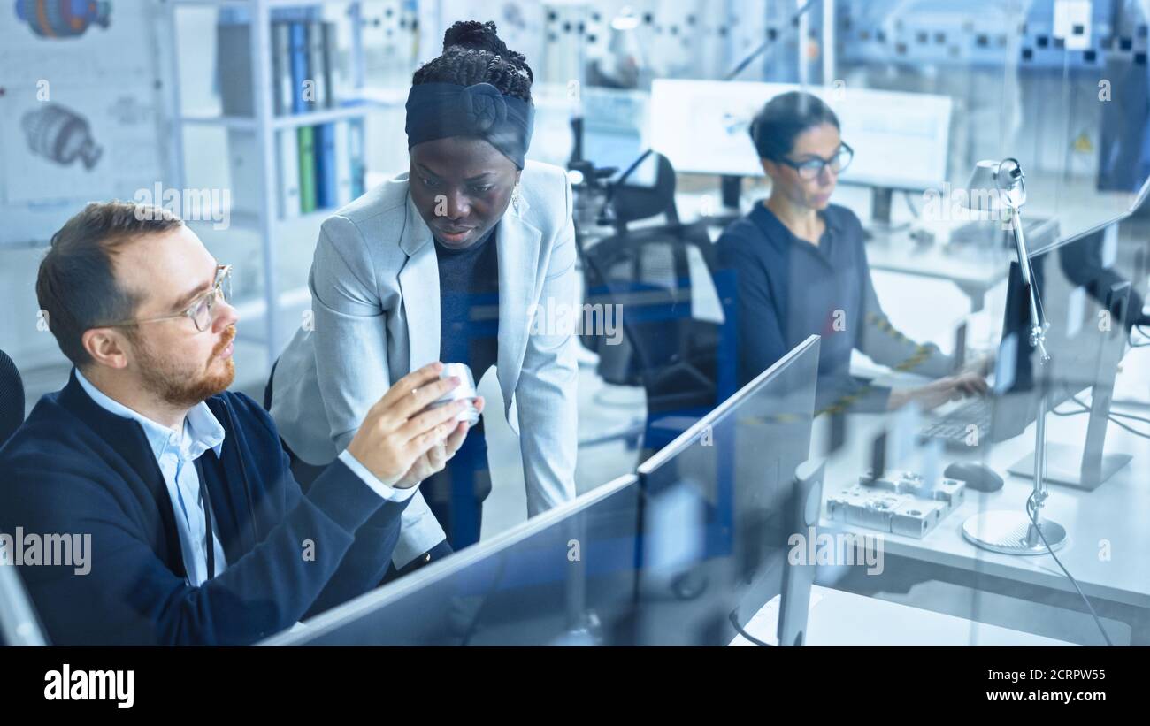 Male colleagues discussing work mechanism hi-res stock photography and ...