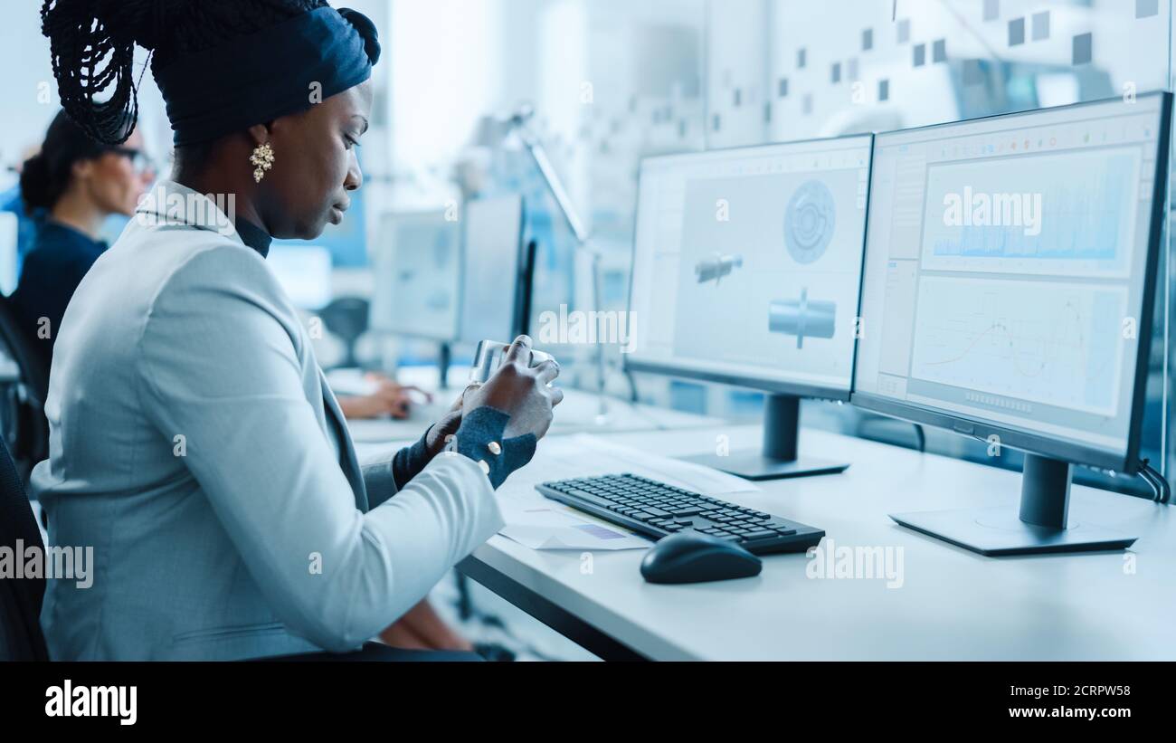 Beautiful Female Engineer Working on Personal Computer in the High-Tech ...