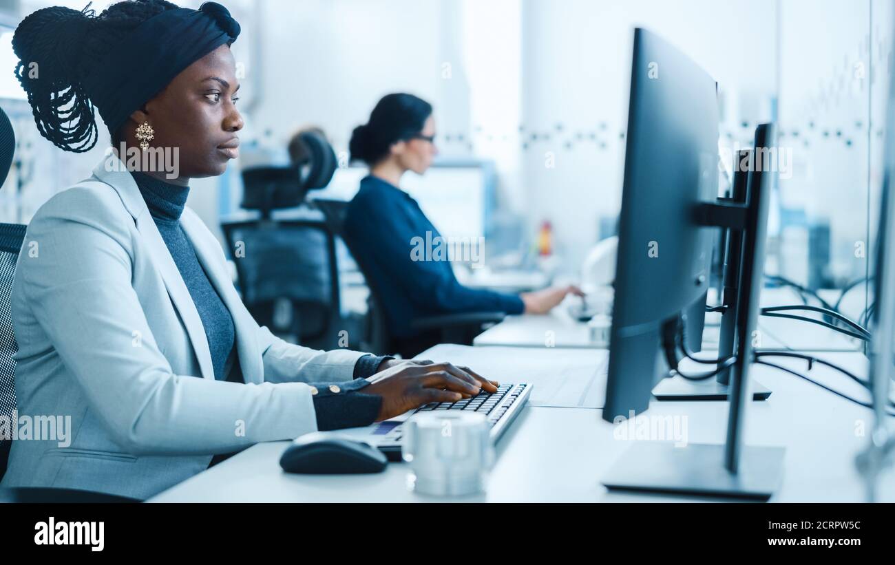 Beautiful Female Engineer Working on Personal Computer in the High-Tech ...