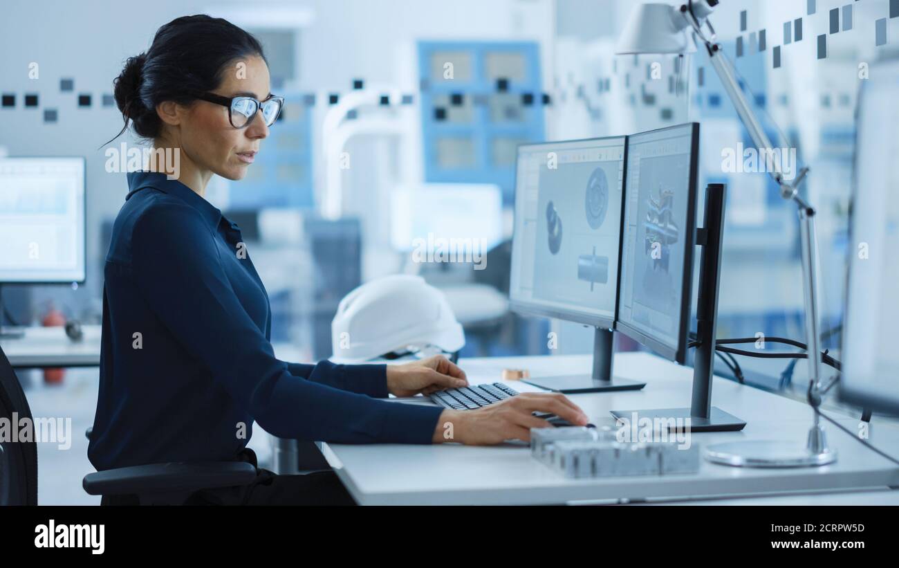 Beautiful Female Engineer Working on Personal Computer in the High-Tech ...