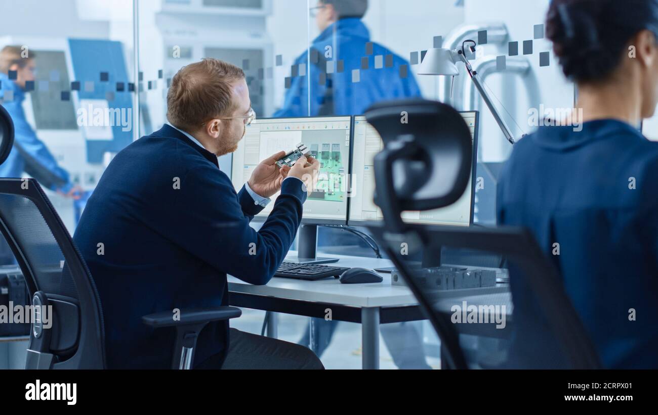 Electronics Factory: Male Electrical Engineer Holds PCB Prototype ...