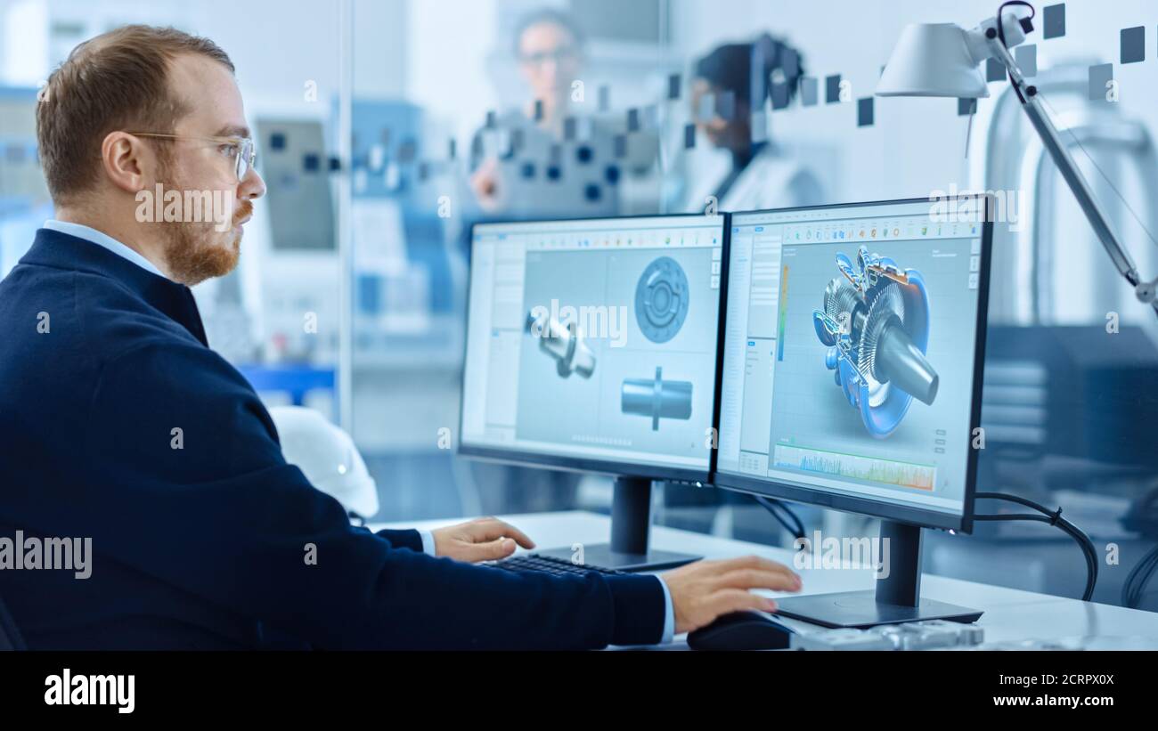 Heavy Industry Engineer Working on Personal Computer, Screen Shows CAD ...