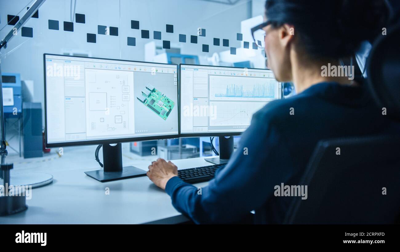 Modern Electronics Factory: Female Electrical Engineer Works on ...