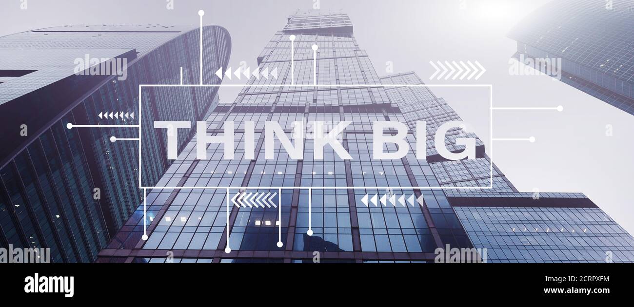 Think big text over tall office buildings Stock Photo - Alamy
