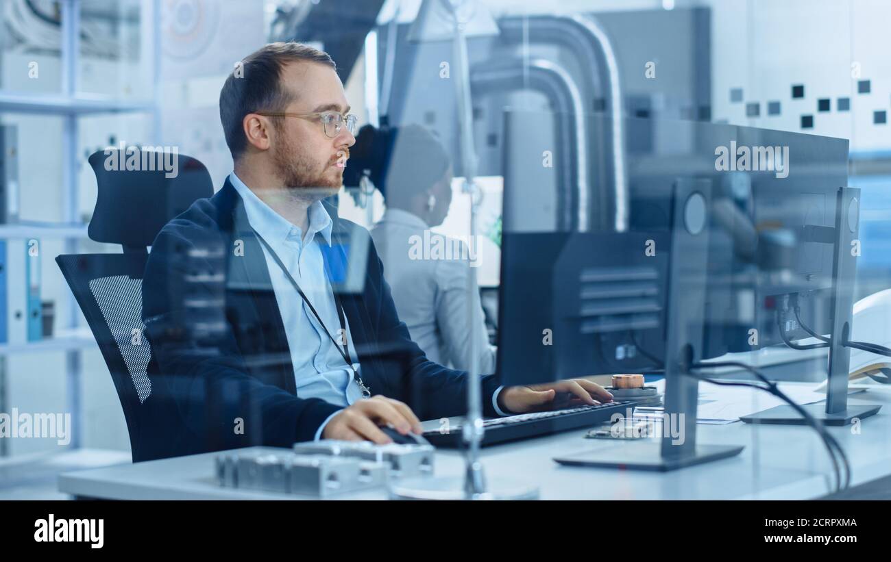 Factory Office: Industrial Engineer working on Personal Computer, On ...