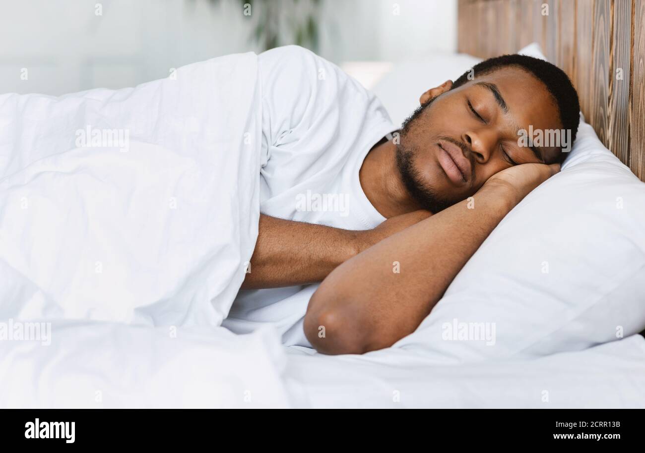 African American Guy Sleeping Resting In His Bed At Home Stock Photo ...