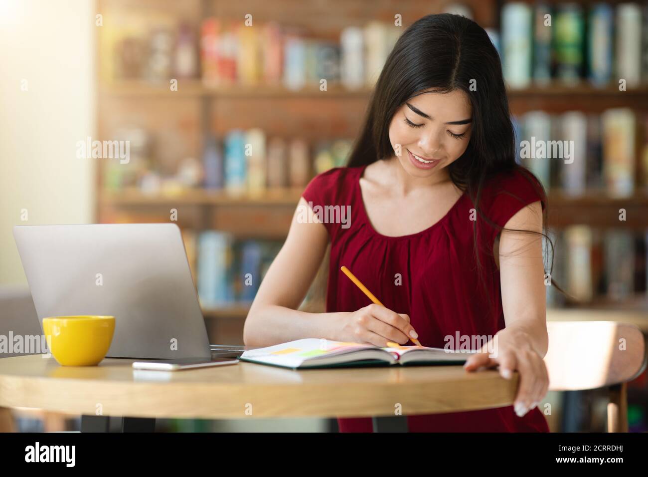 Planning Work Schedule. Asian Freelancer Woman Taking Notes To Notepad ...