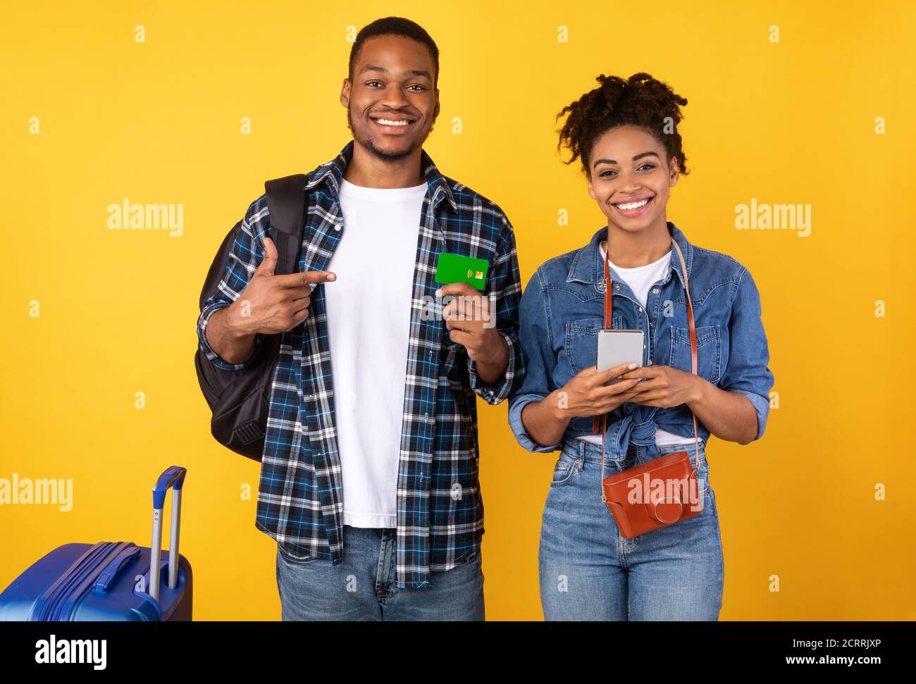 Couple Holding Credit Card And Smartphone Booking Tickets, Yellow ...
