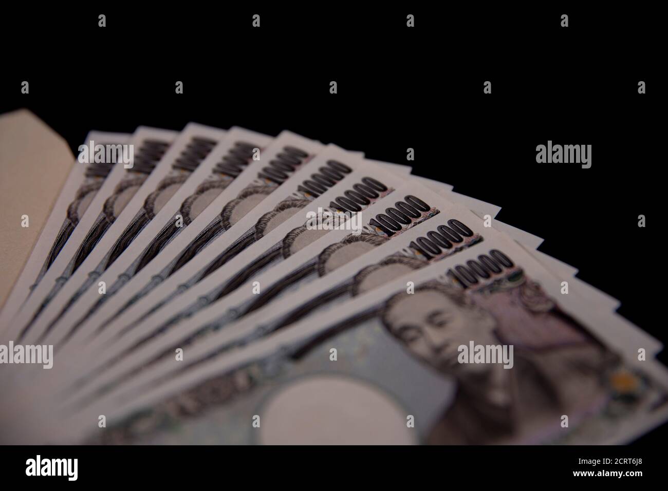 Japanese currency 100,000 yen with envelope on the black background ...