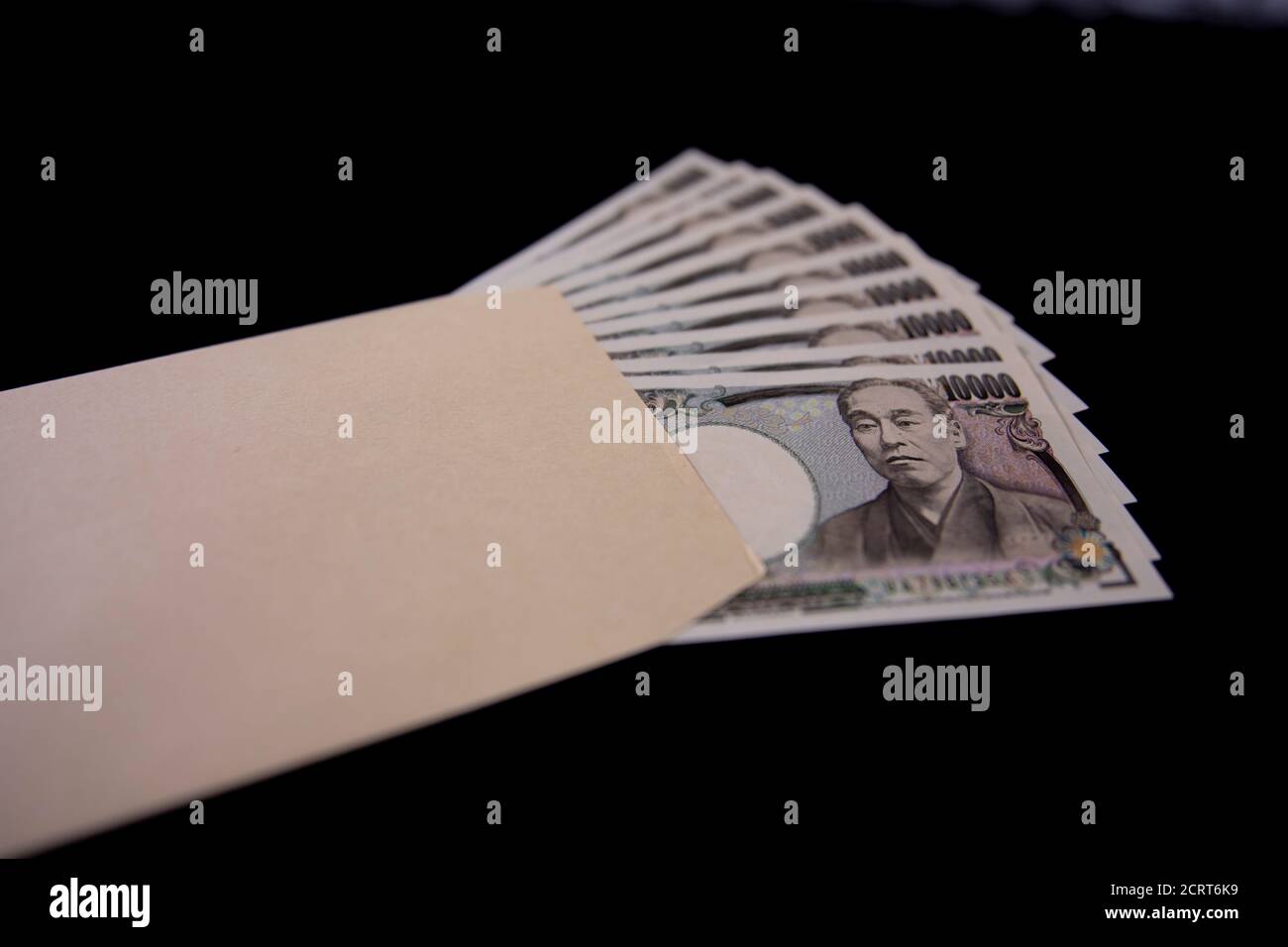 Japanese currency 100,000 yen with envelope on the black background ...