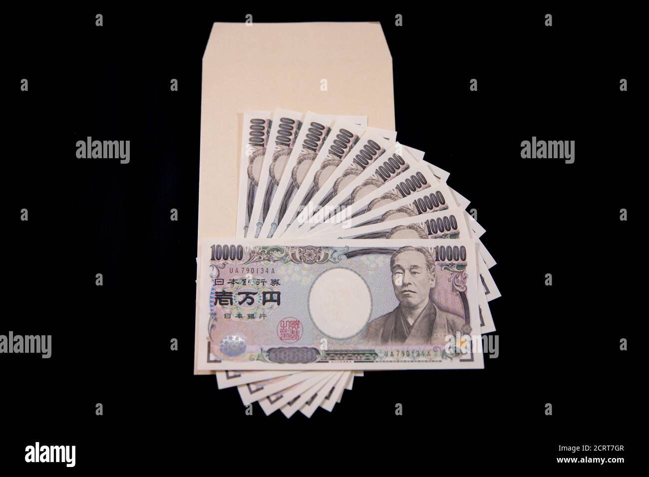 Japanese currency 100,000 yen with envelope on the black background ...