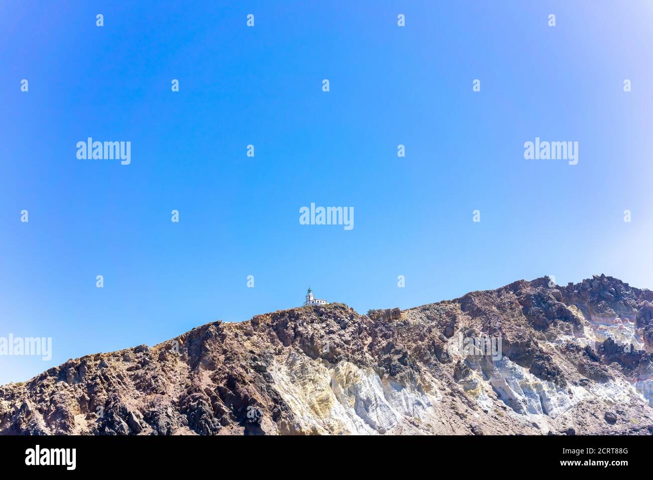 Cliff and lighthouse on the southern of Thira island in Greek Islands ...