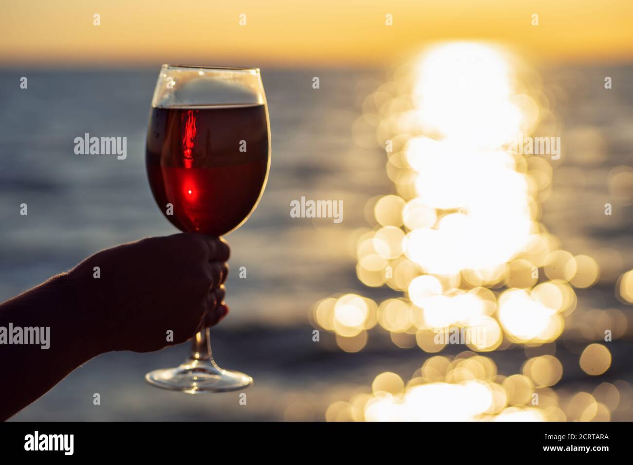 glass of red wine in hand Stock Photo - Alamy
