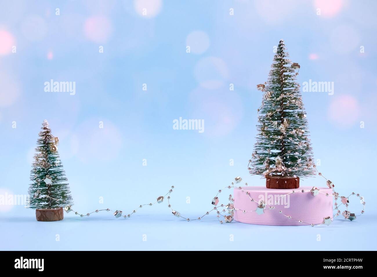 Christmas trees or New Year trees with Christmas decorations and pink ...