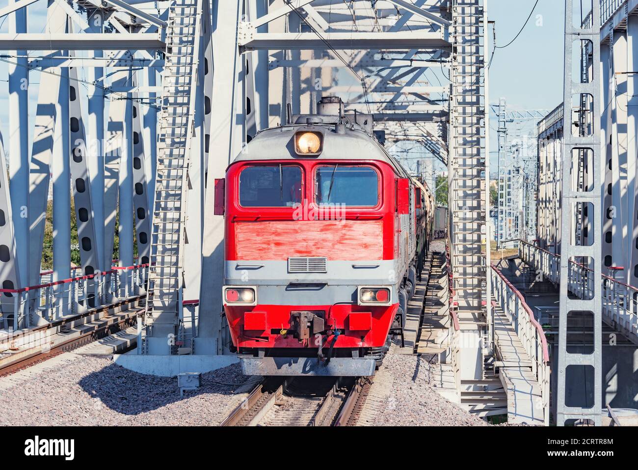 Diesel freight train moves through the bridge Stock Photo - Alamy