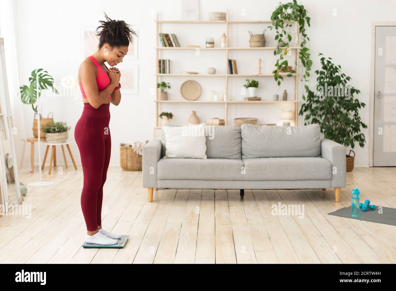 Happy Black Woman Weighing Herself On Weight-Scales Losing Weight ...