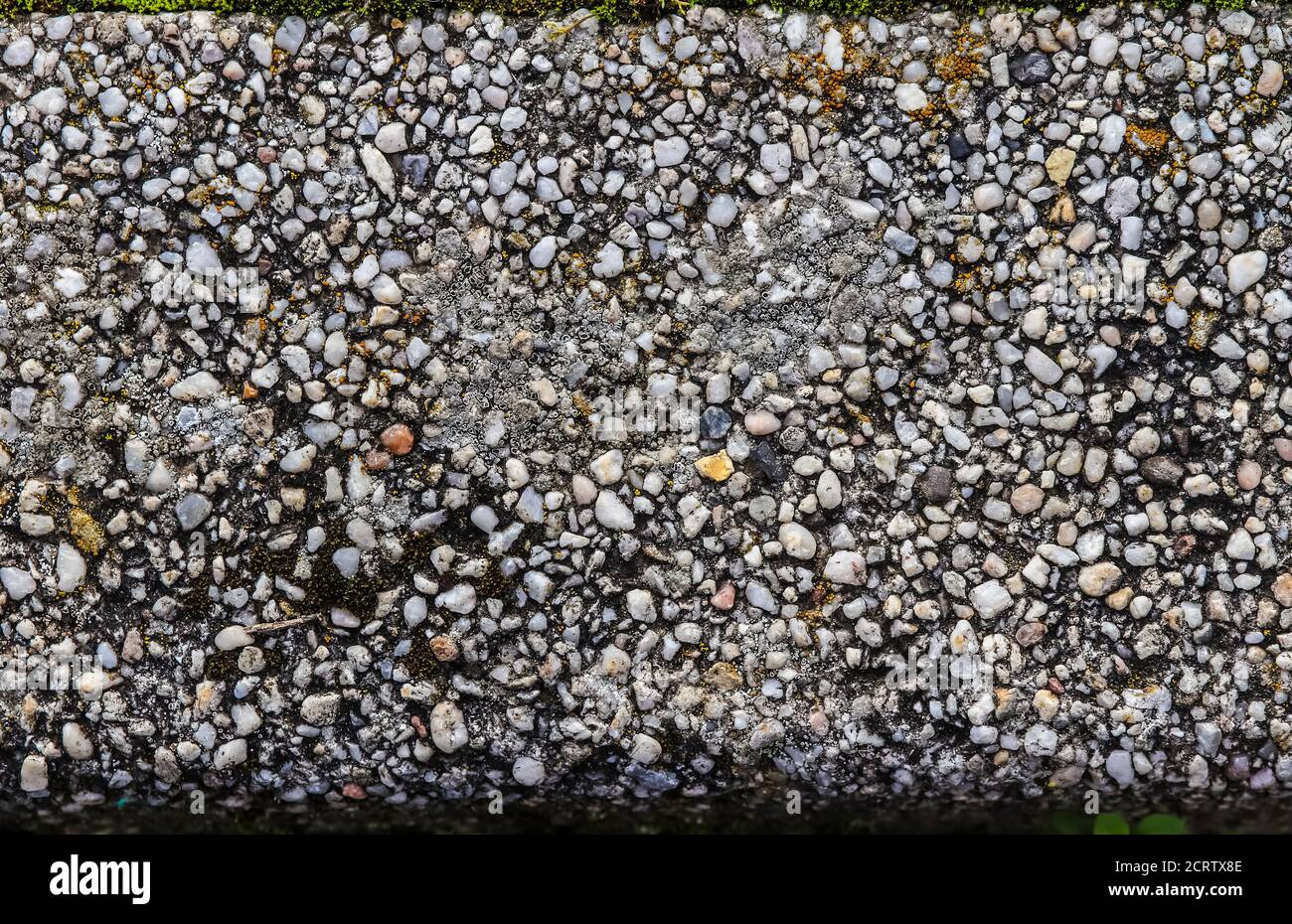 Detailed close up view on pebbles and stones on a gravel ground texture ...