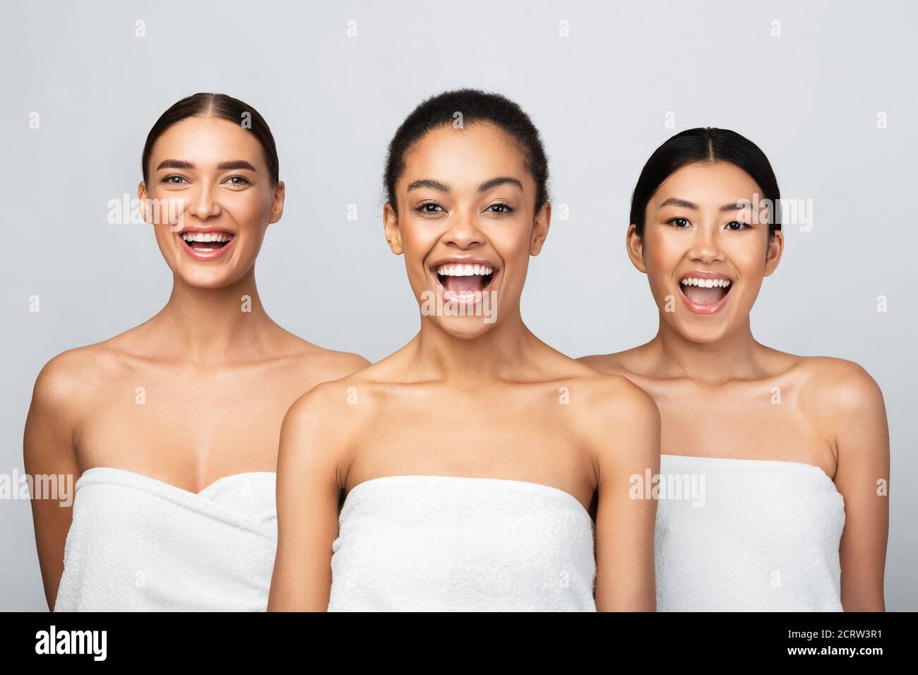 Playful Ladies Posing Wrapped In White Bath Towels, Gray Background ...